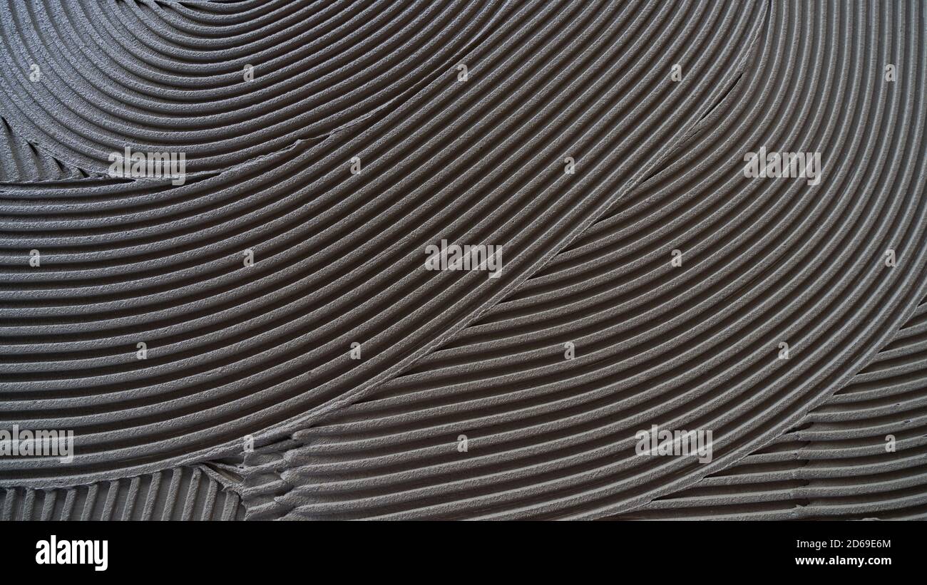 cementitious adhesive applied to the floor ready to receive the ceramic ...