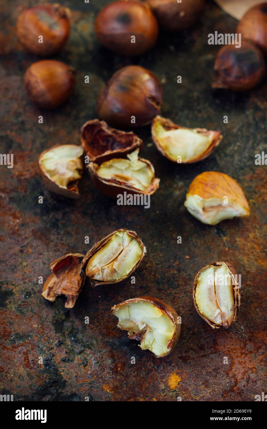 Peeled roasted chestnuts on black rustic surface Stock Photo - Alamy