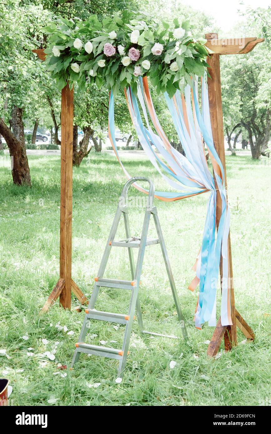 Setting of wedding arch - wedding arch and stepladder Stock Photo - Alamy