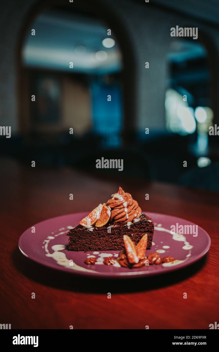 Vertical shot of a slice of chocolate cake decorated with fruit Stock ...