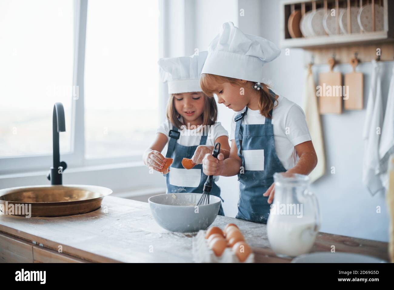 Family kids in white chef uniform preparing food on the kitchen Stock ...