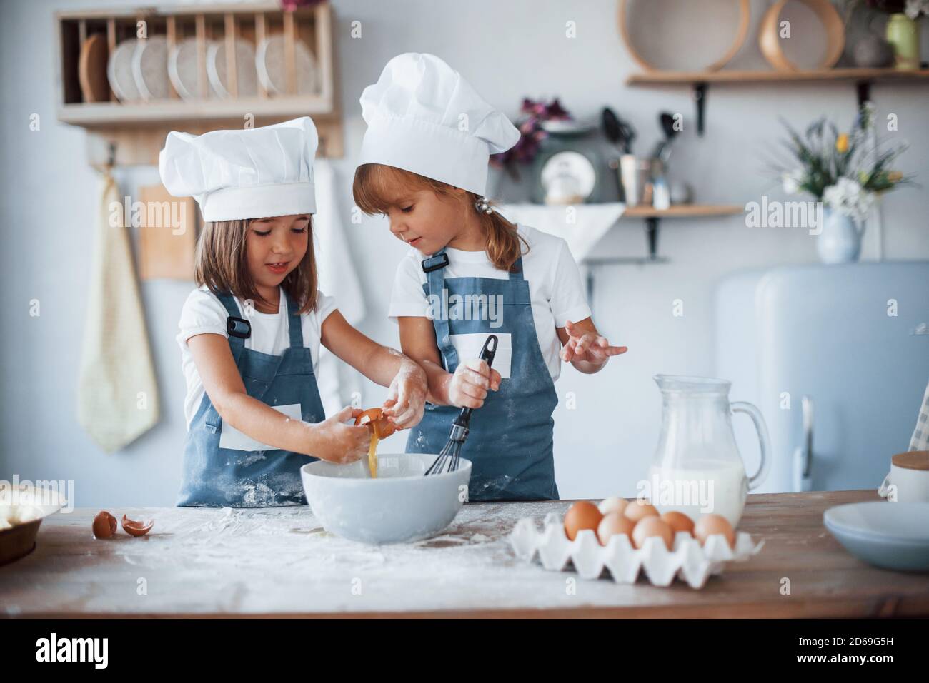 Family kids in white chef uniform preparing food on the kitchen Stock ...