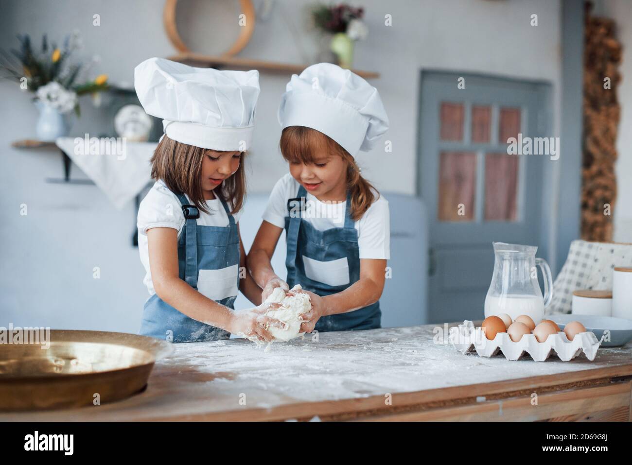 Family kids in white chef uniform preparing food on the kitchen Stock ...