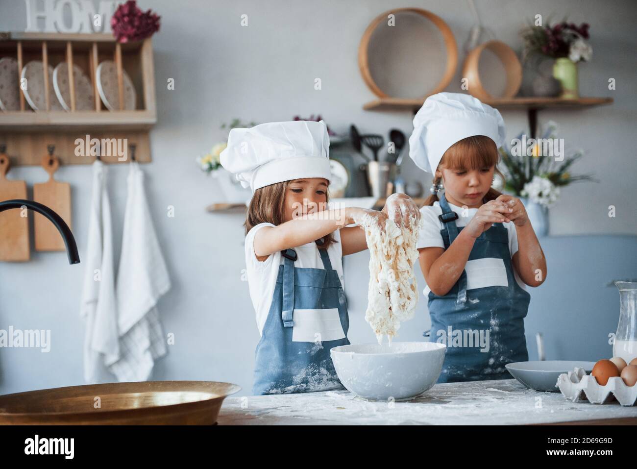 Family kids in white chef uniform preparing food on the kitchen Stock ...