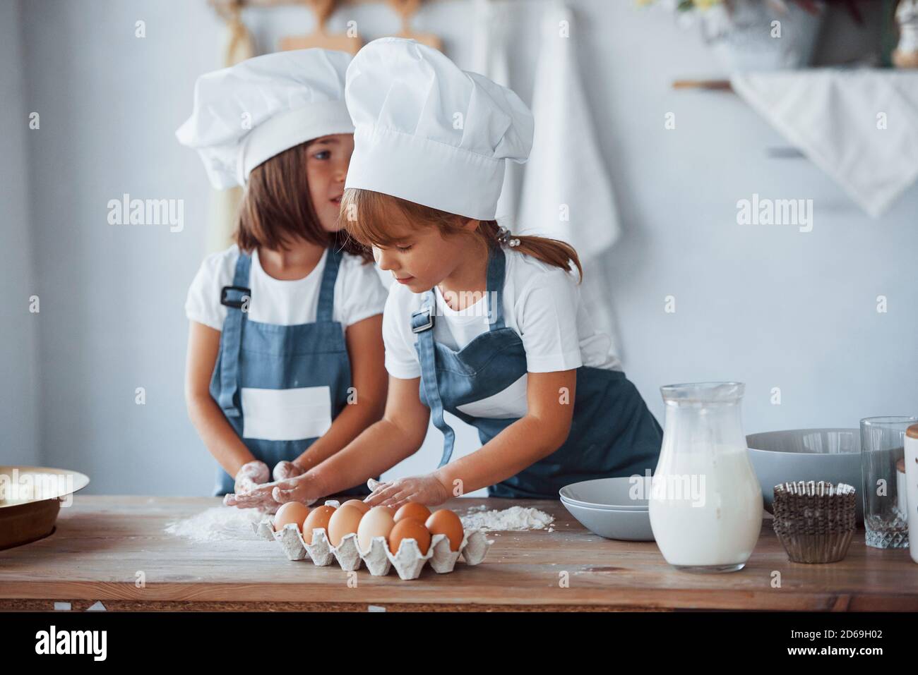 Family kids in white chef uniform preparing food on the kitchen Stock ...
