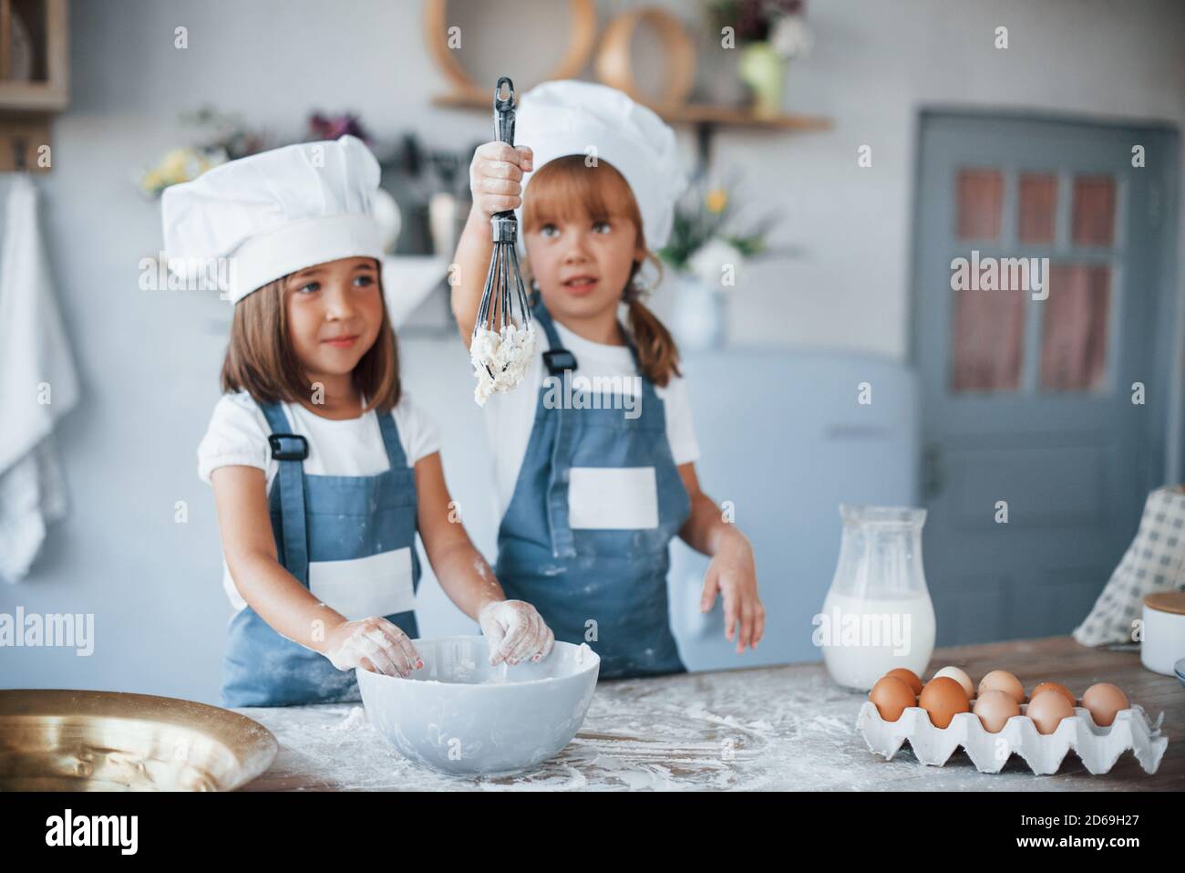 Family kids in white chef uniform preparing food on the kitchen Stock ...