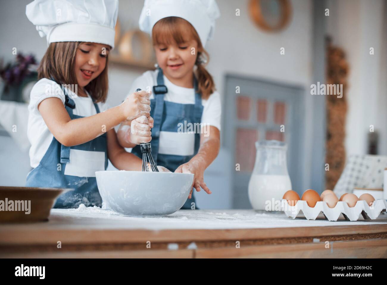 Family kids in white chef uniform preparing food on the kitchen Stock ...