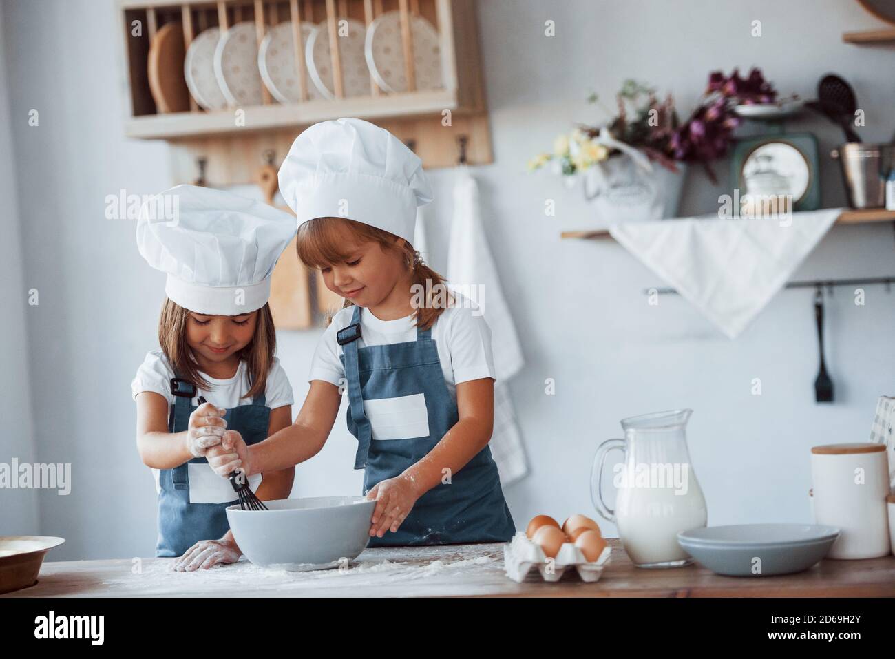 Family kids in white chef uniform preparing food on the kitchen Stock ...
