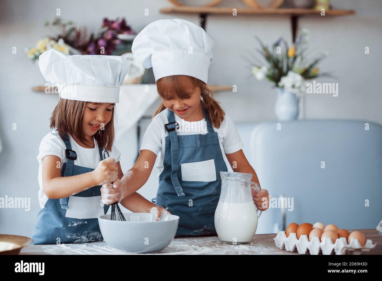 Family kids in white chef uniform preparing food on the kitchen Stock ...