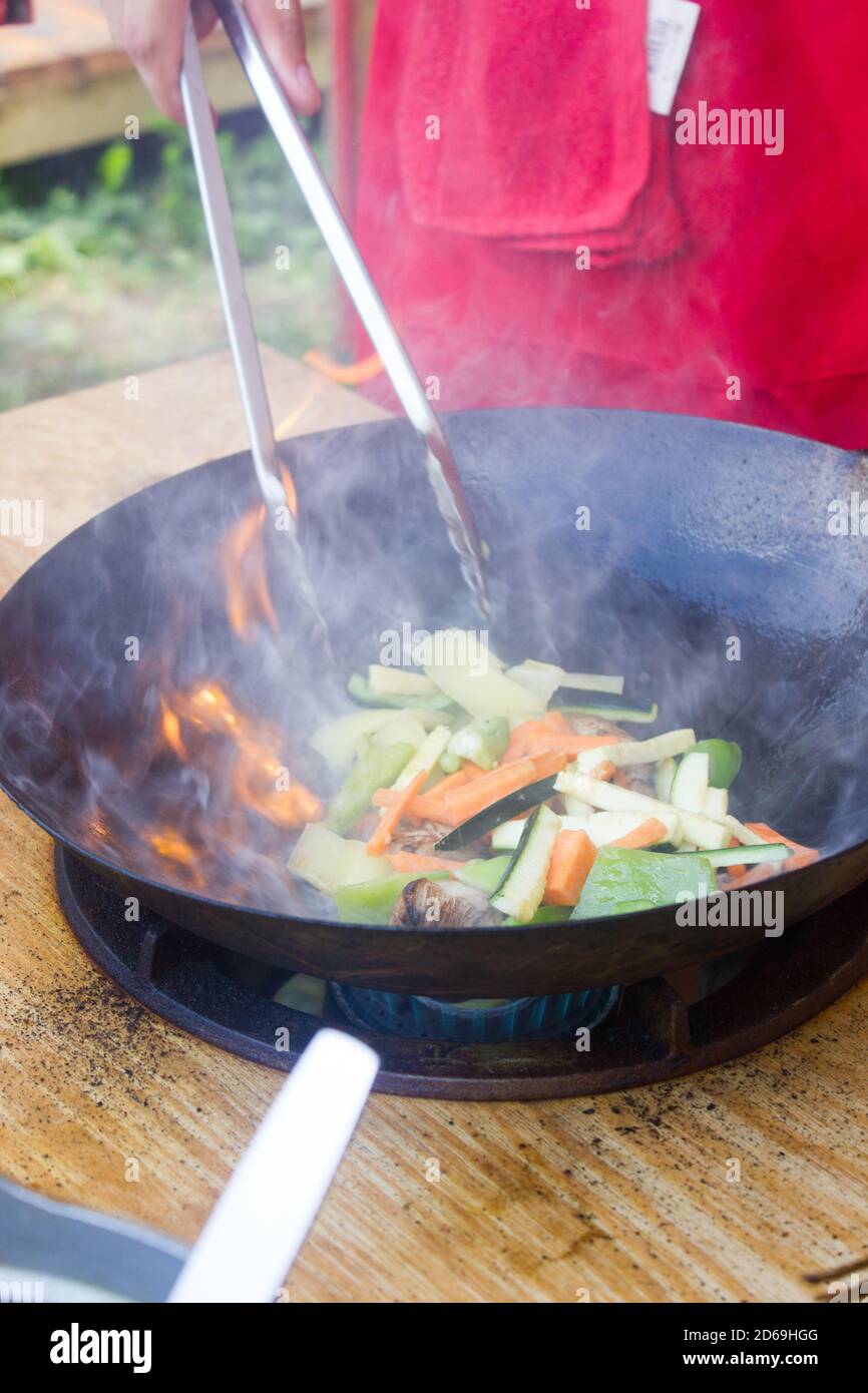 Traditional chinese food - wok cooking on open fire Stock Photo - Alamy