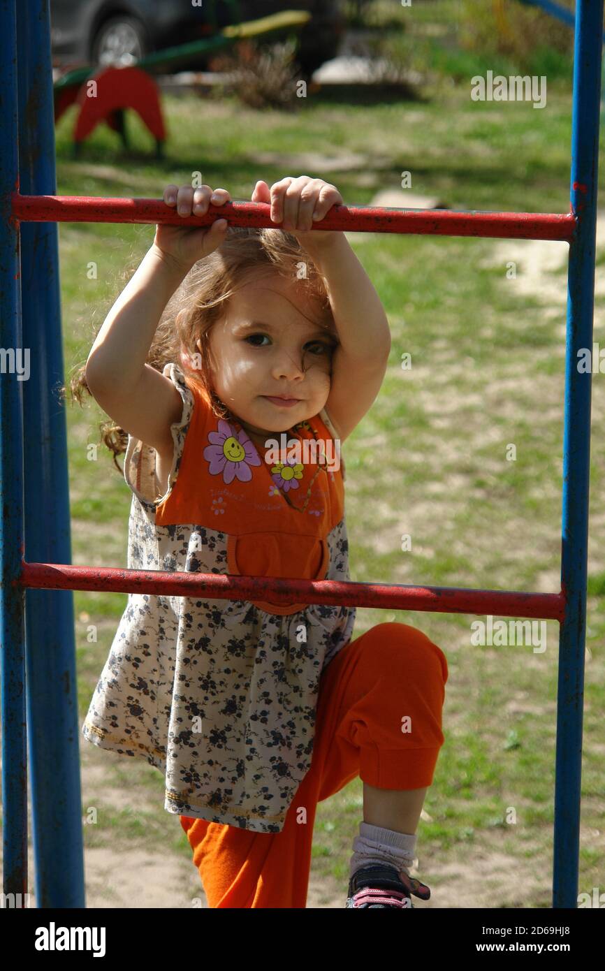 Adorable little girl climbing up on stairs on the playground Stock ...