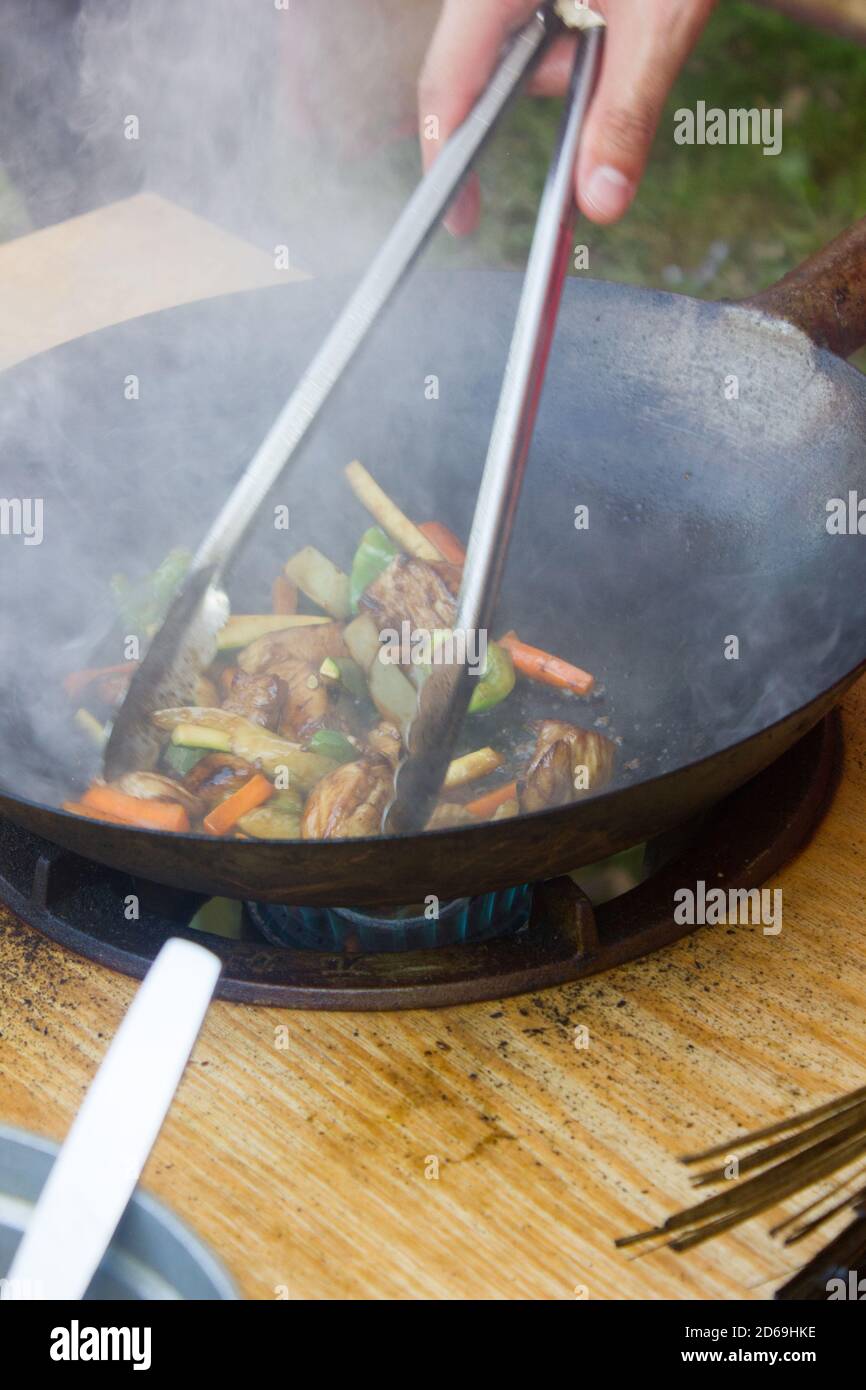 Traditional chinese food - wok cooking on open fire Stock Photo - Alamy
