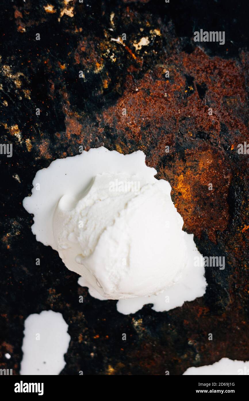 Ball of melted ice cream on black rustic surface Stock Photo - Alamy