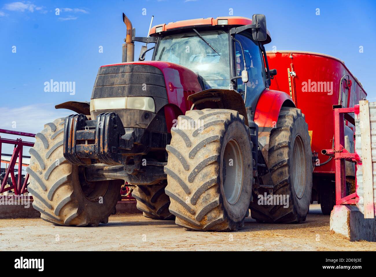 Modern red agricultural tractor in a farm Stock Photo - Alamy