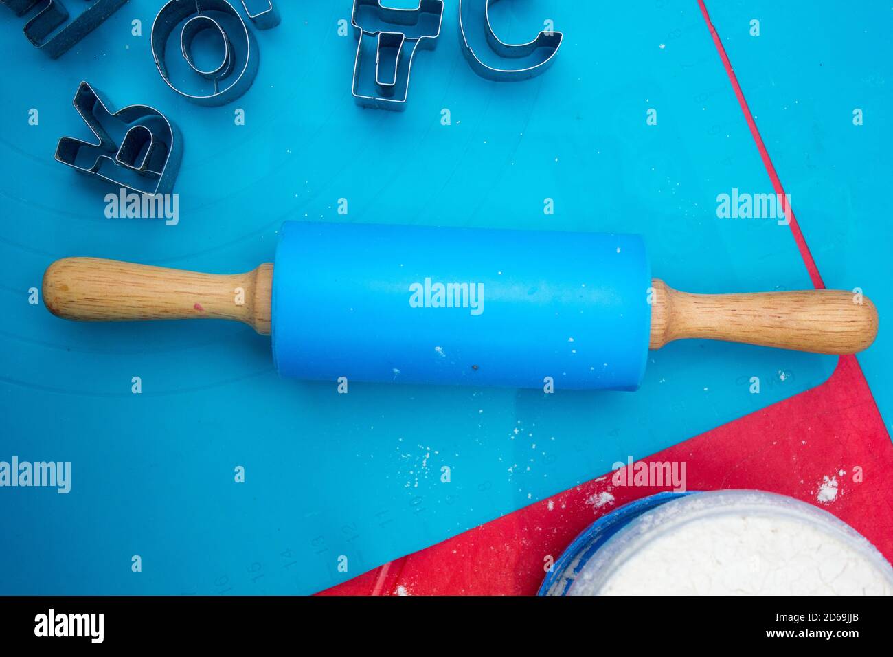Blue rolling pin with letters forms Stock Photo - Alamy