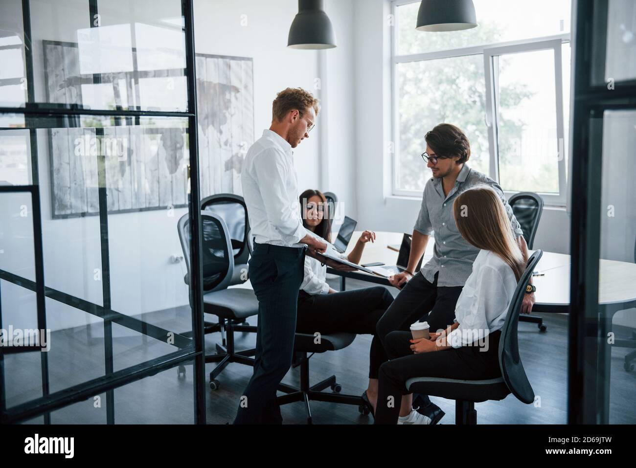 Active conversation. Young business people in formal clothes working in ...