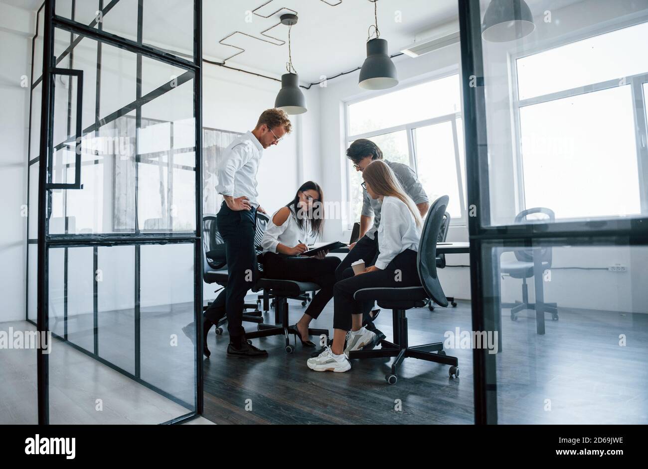 Active conversation. Young business people in formal clothes working in ...