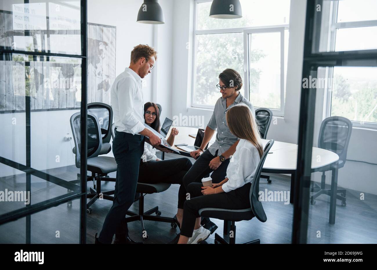 Active conversation. Young business people in formal clothes working in ...