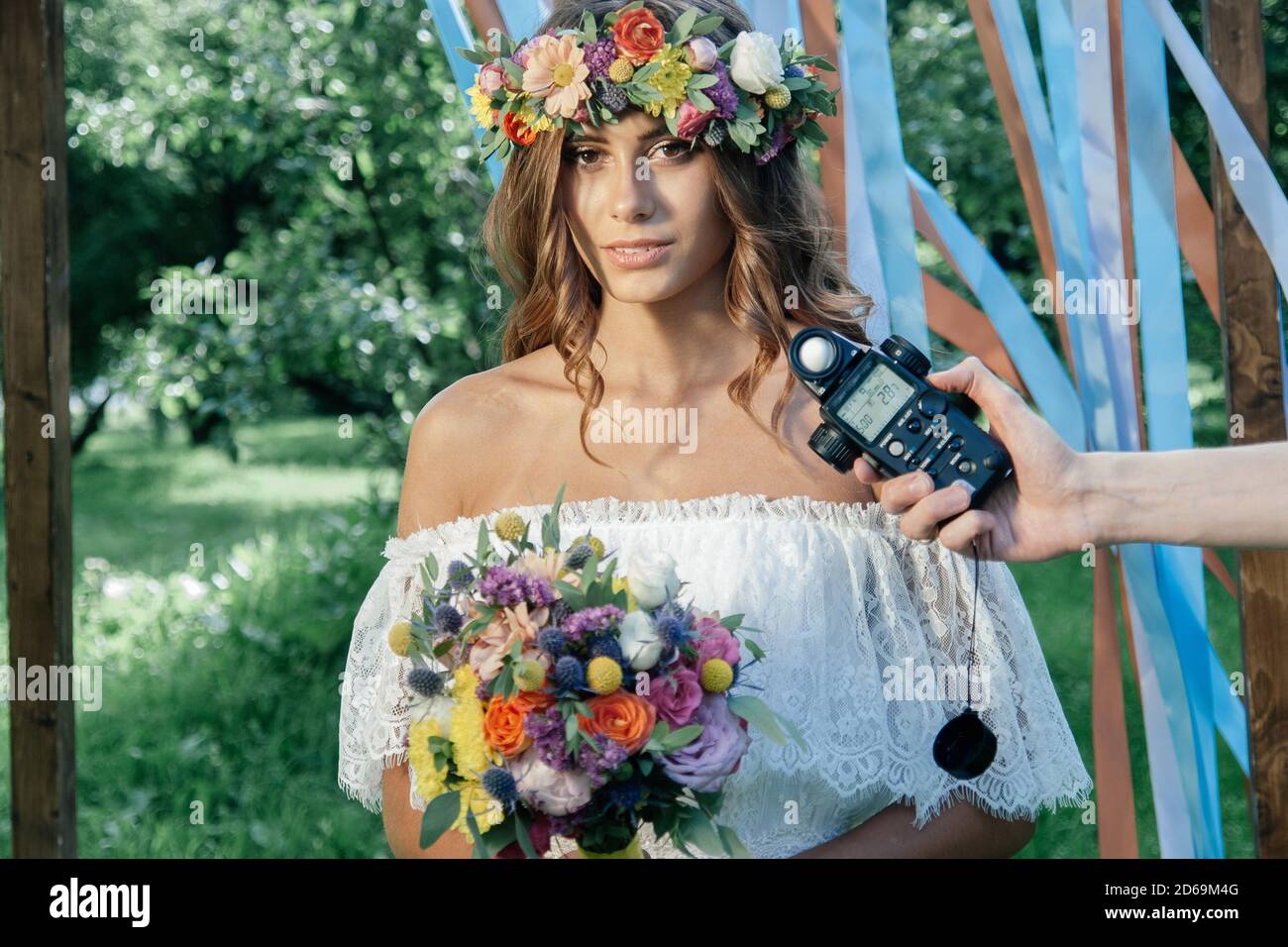 Photographer measuring light with light meter on beautiful girl Stock ...