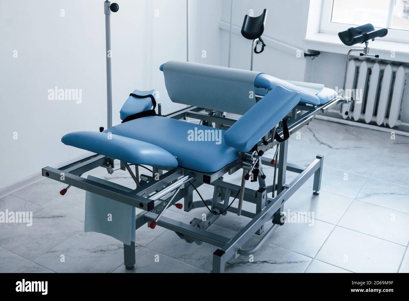 Blue colored obstetric bed indoors in the clinic cabinet at daytime ...