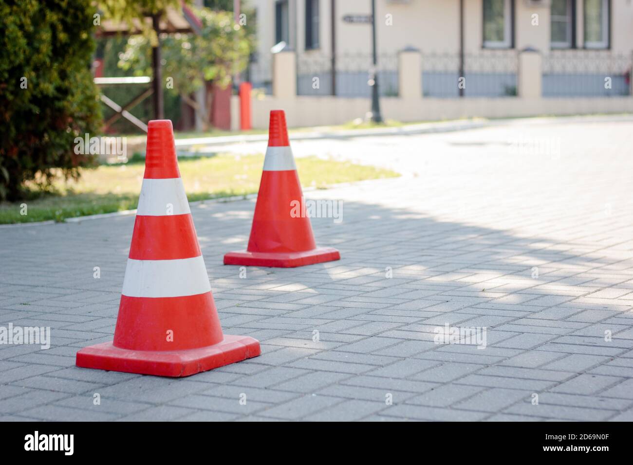 Orange road cone staying at the street Stock Photo - Alamy