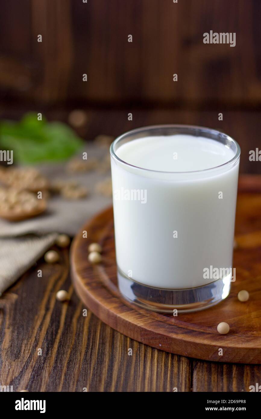 Soybean milk with soy beans around it Stock Photo - Alamy
