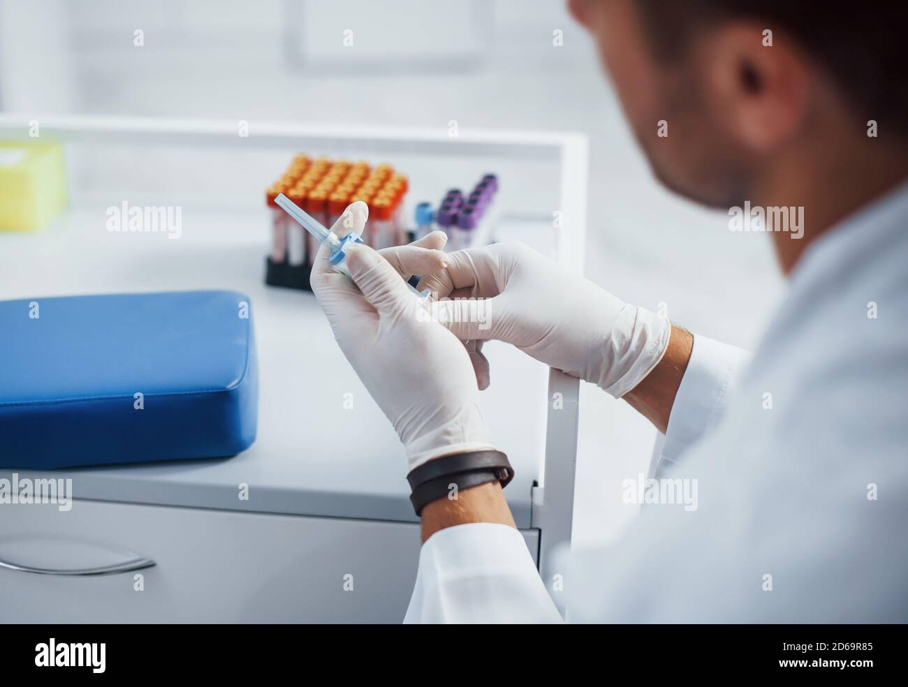 Male doctor with syringe is preparing for the blood sampling in the ...