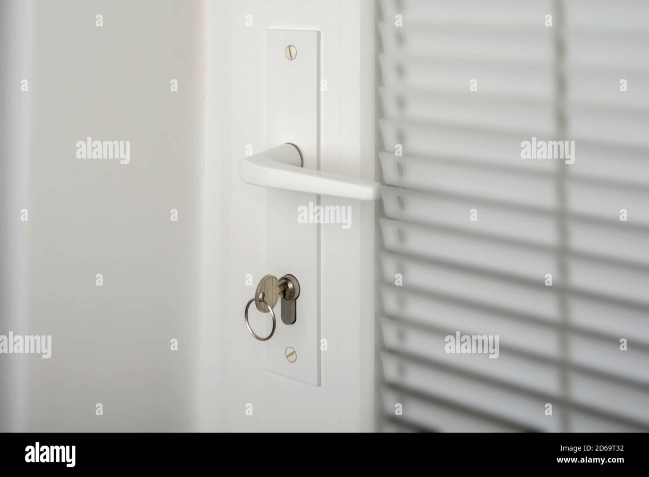 Door handle and a key on a plastic door Stock Photo - Alamy