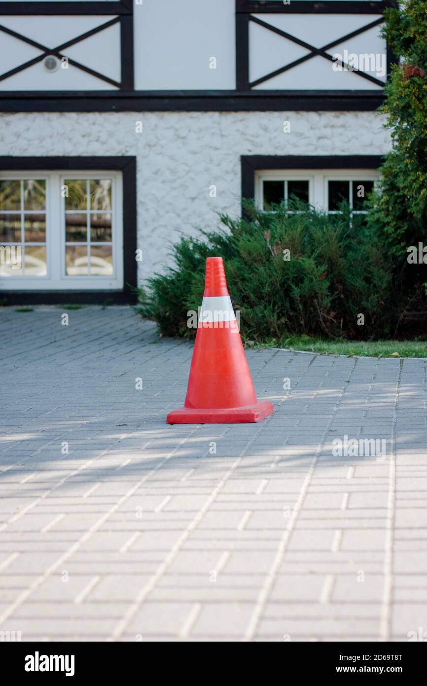 Orange road cone staying at the street Stock Photo - Alamy