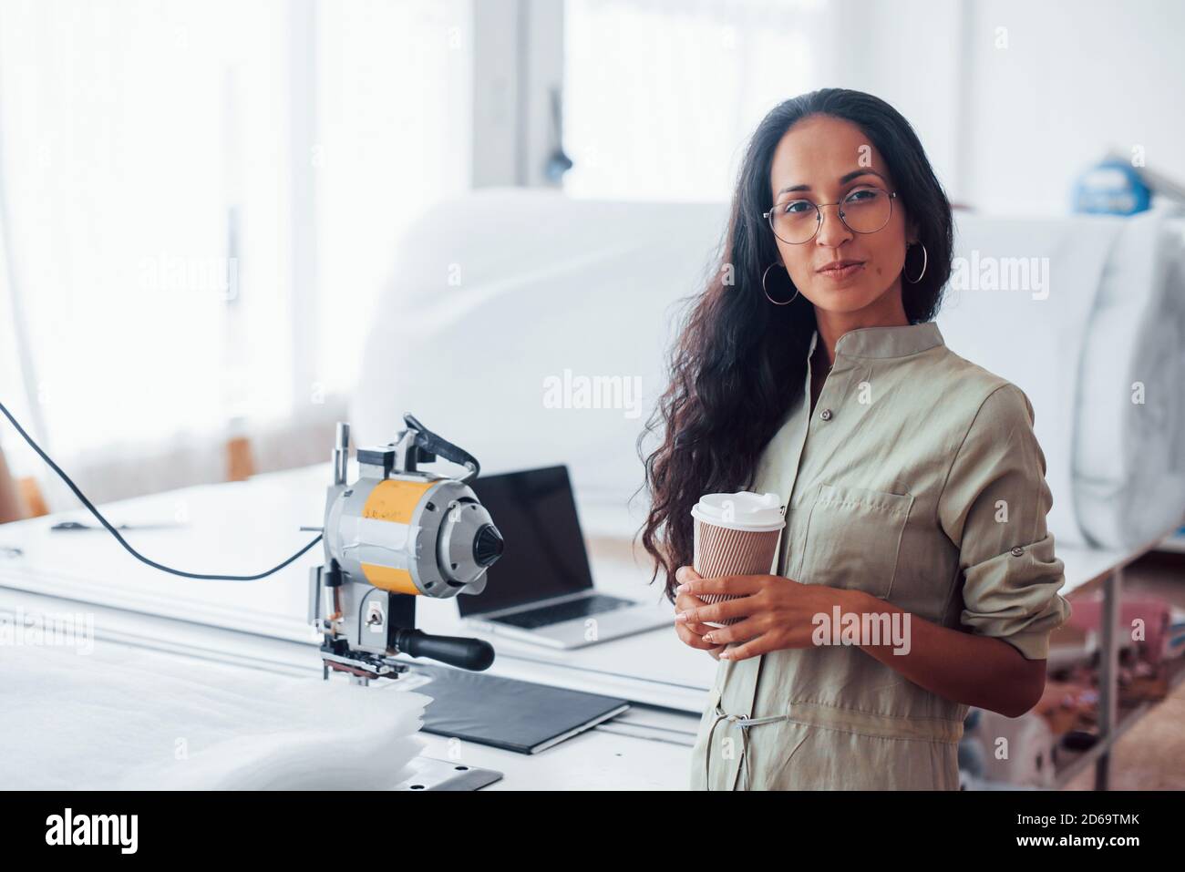 Beautiful female worker with glasses is in the sewing factory Stock ...