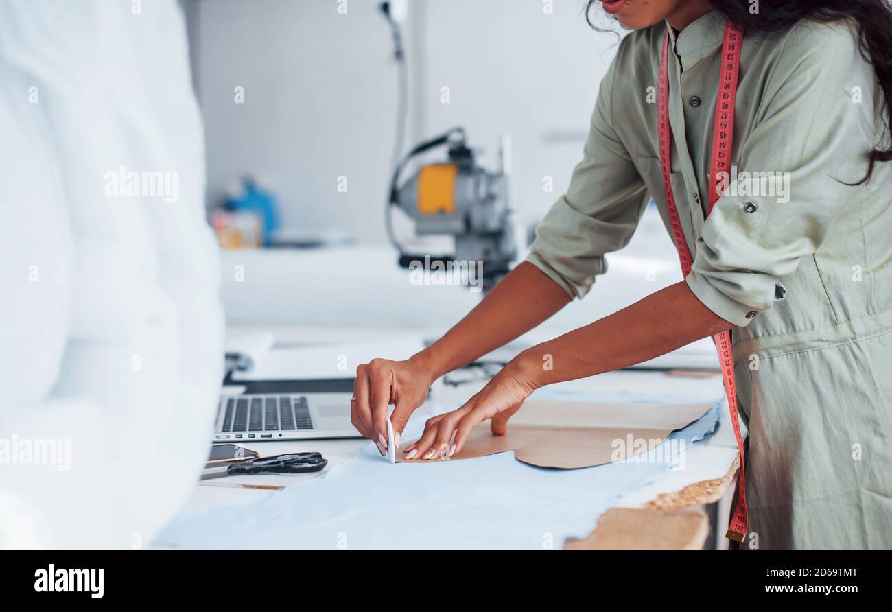 Busy with cloth. Female worker is in the sewing factory Stock Photo - Alamy