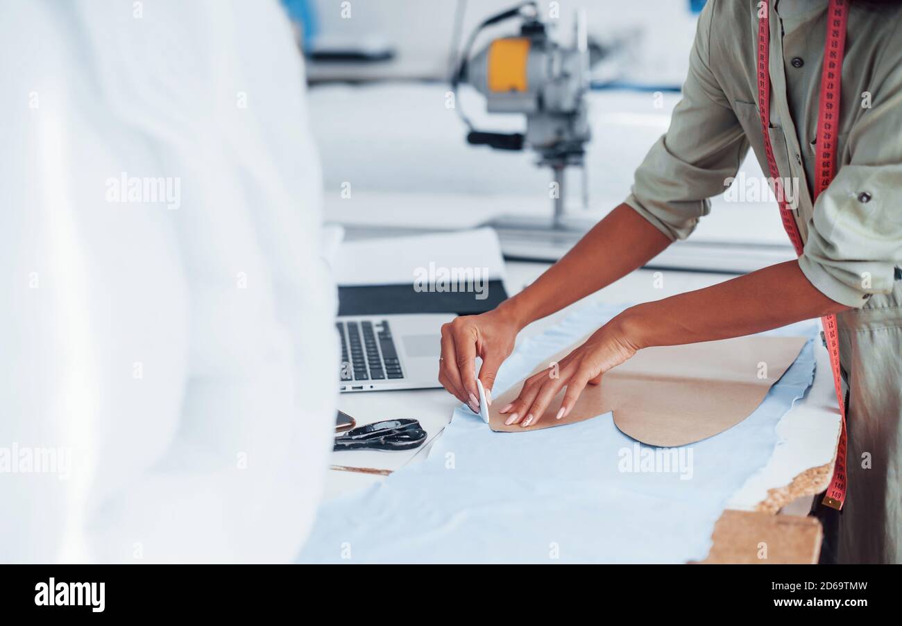 Busy with cloth. Female worker is in the sewing factory Stock Photo - Alamy