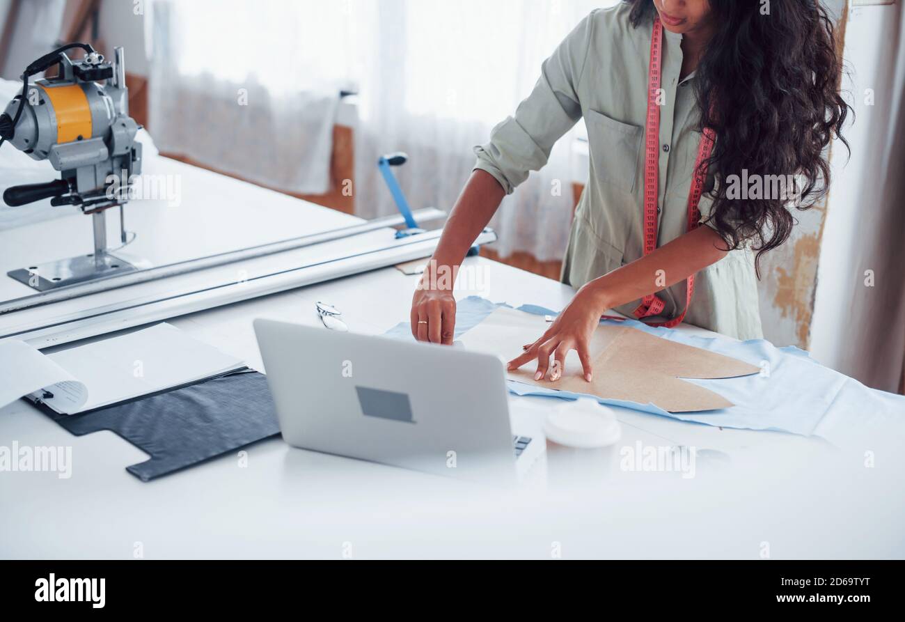 Busy with cloth. Female worker is in the sewing factory Stock Photo - Alamy