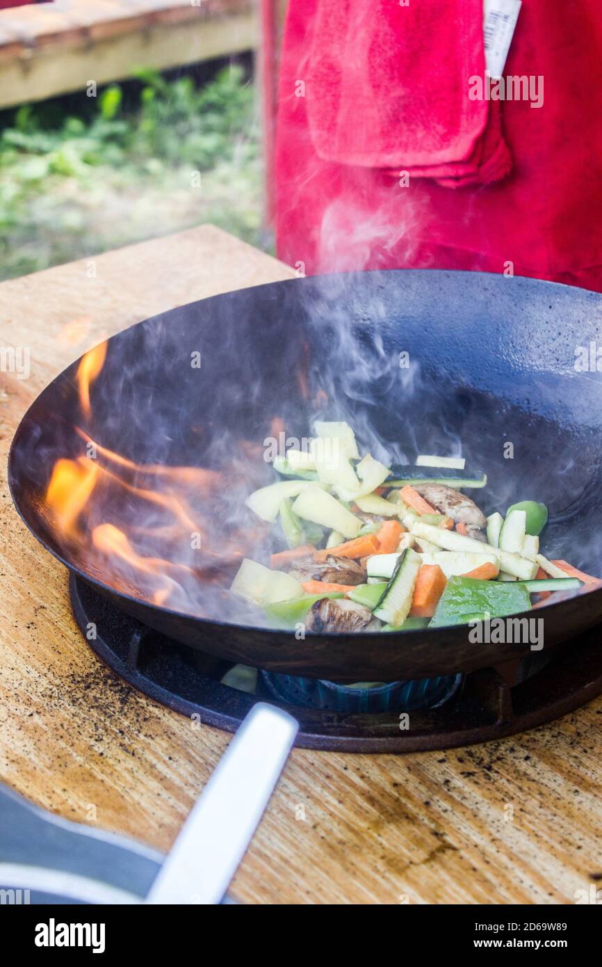 Traditional chinese food - wok cooking on open fire Stock Photo - Alamy