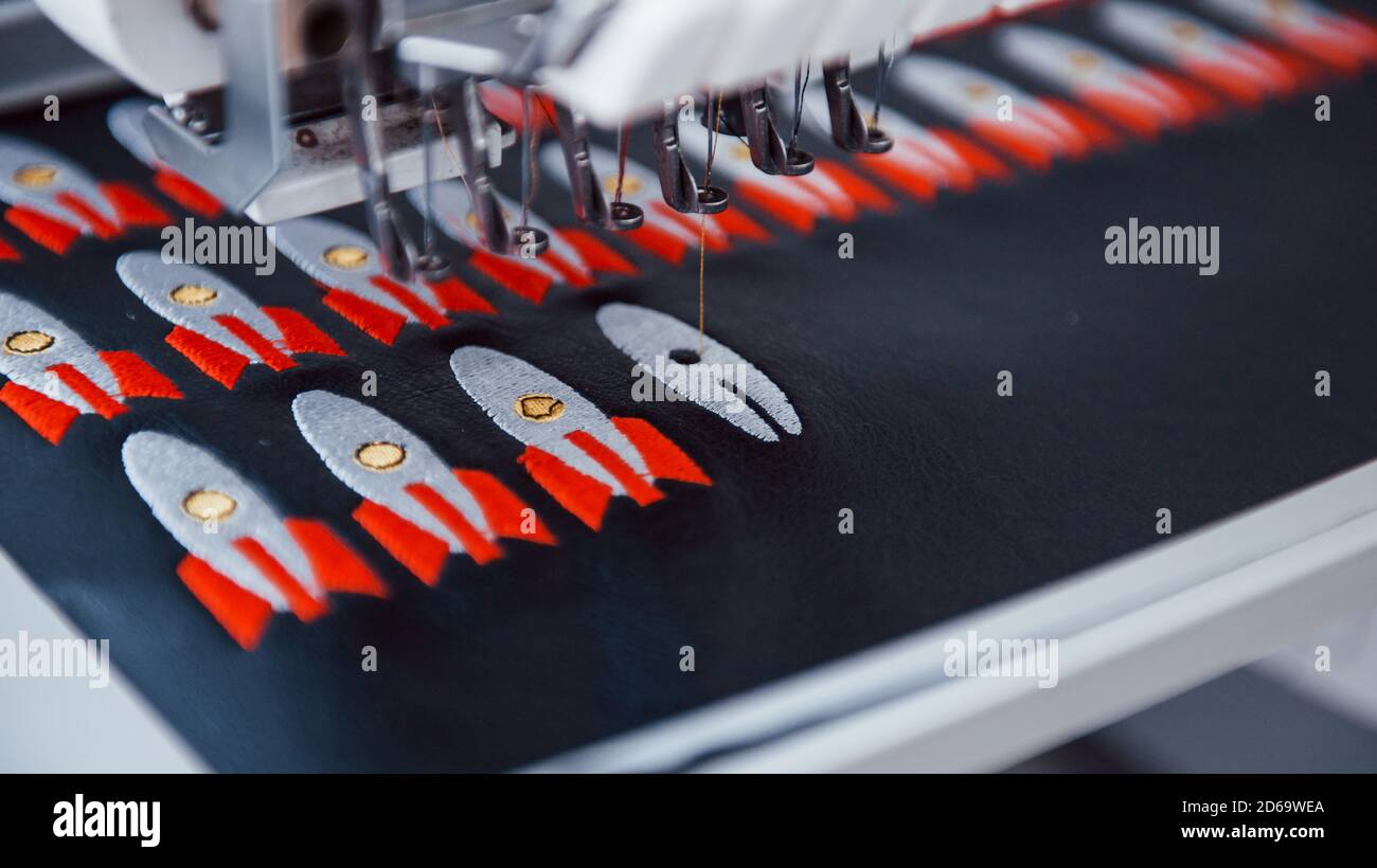 Making rocket pictures. Close up view of white automatic sewing machine ...
