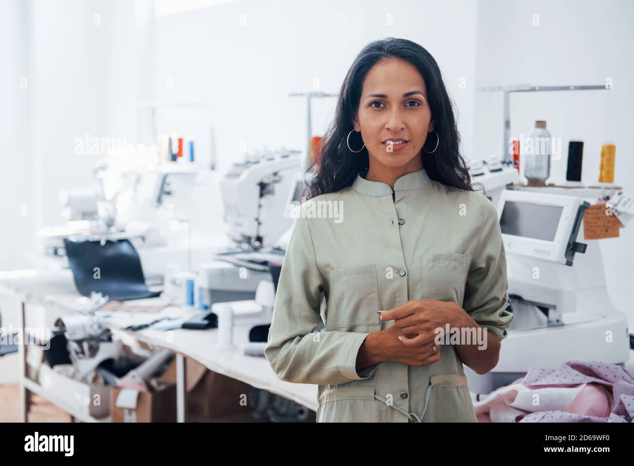 Beautiful female worker is in the sewing factory at daytime Stock Photo ...