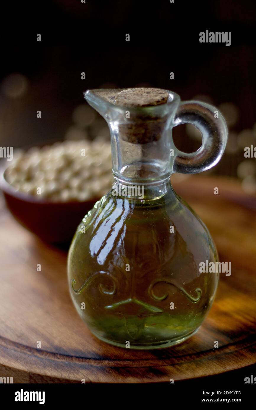 Natural soy bean oil with soybeans near it Stock Photo - Alamy