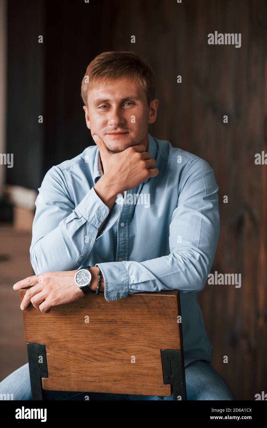 Portrait of man in official shirt that posing for the camera indoors ...