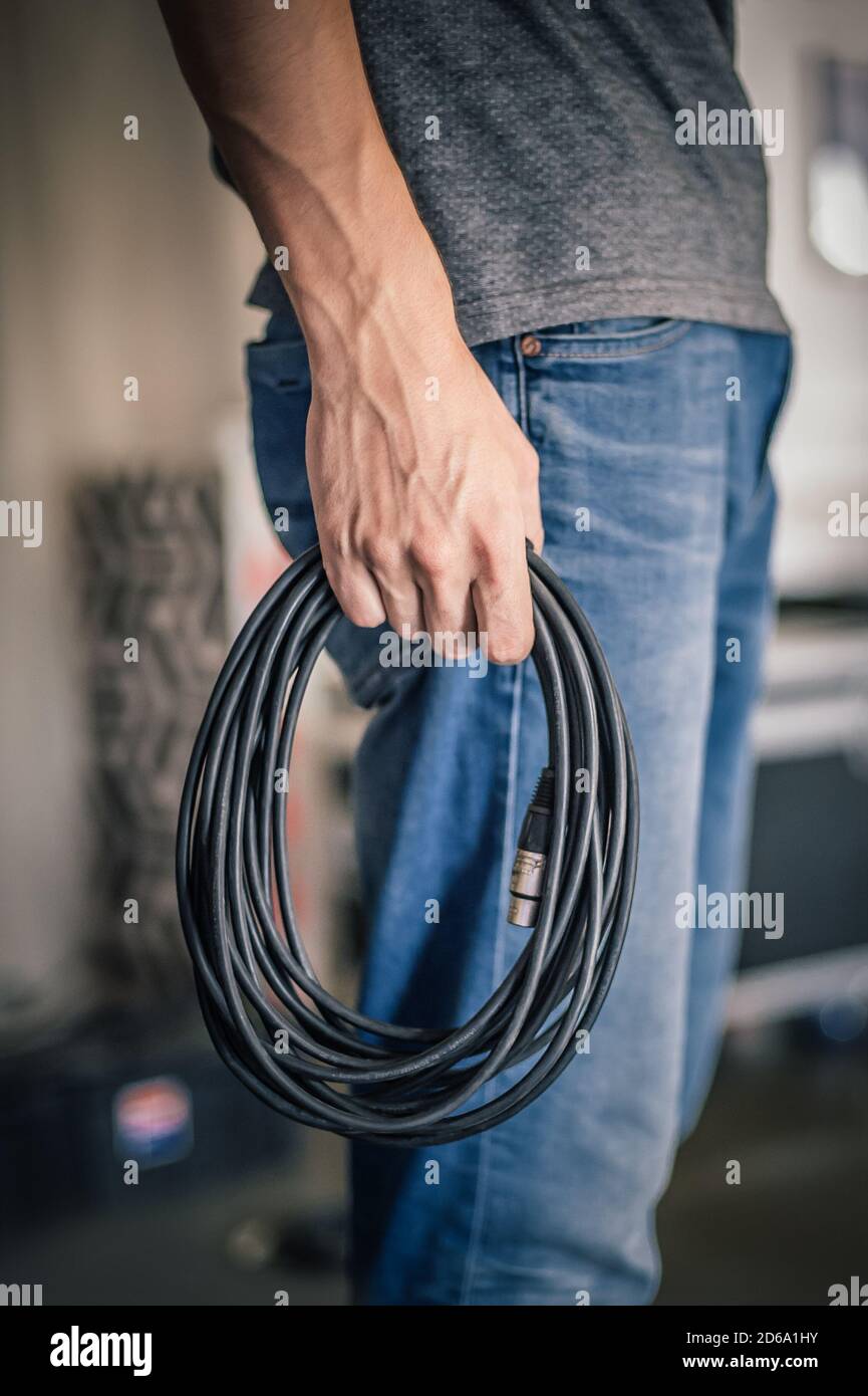 Behind the scene. Sound engineer is connecting the audio cables in the ...