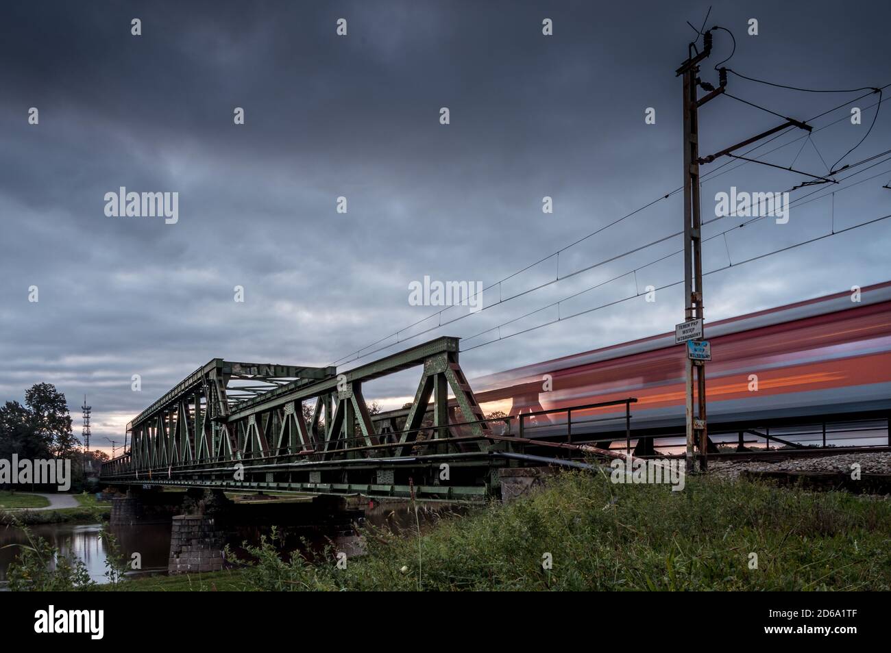 Fast-passing train on the bridge over a river Stock Photo - Alamy