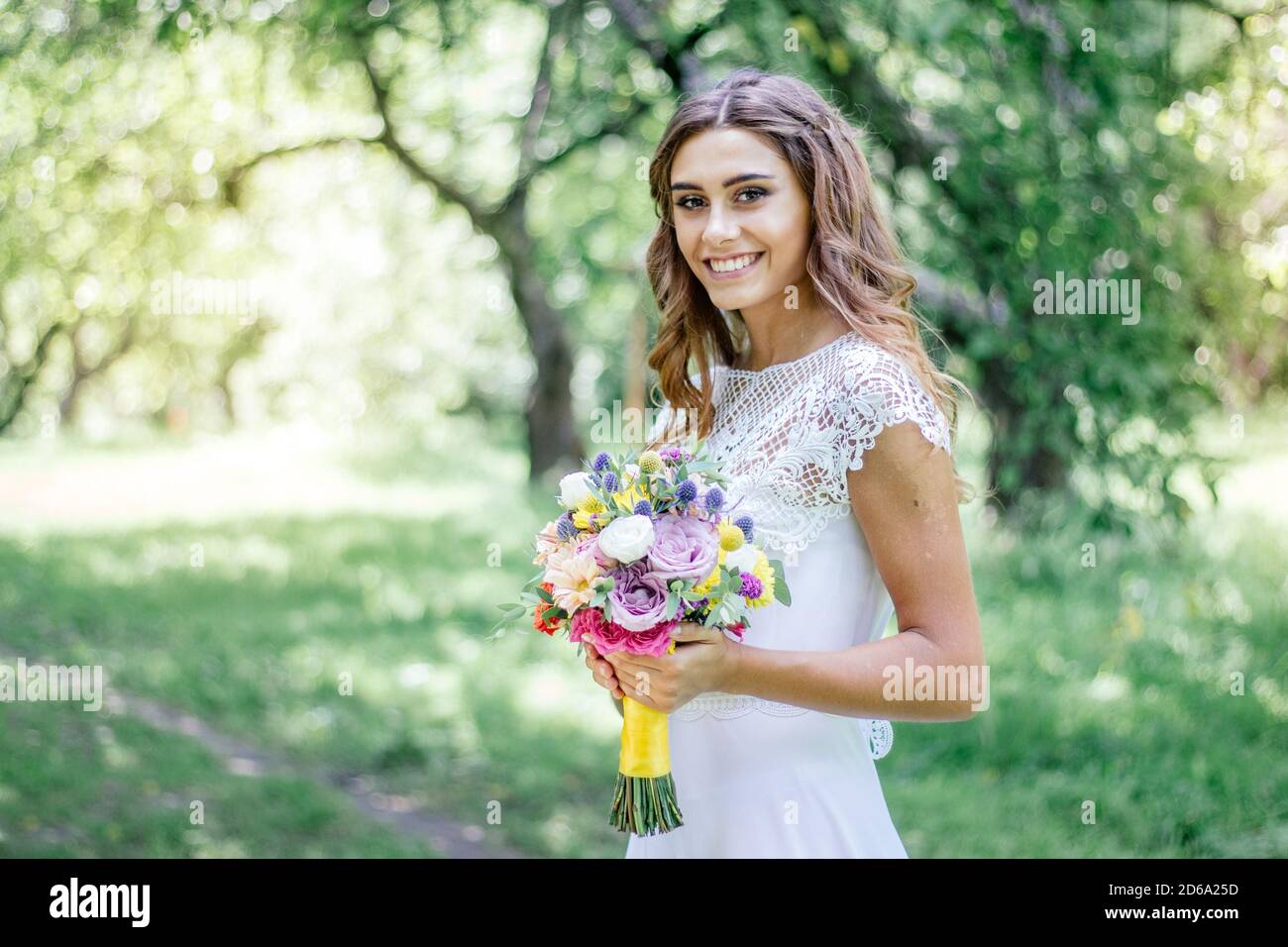 Wedding scene - bride with flower bouquet outdoor Stock Photo - Alamy
