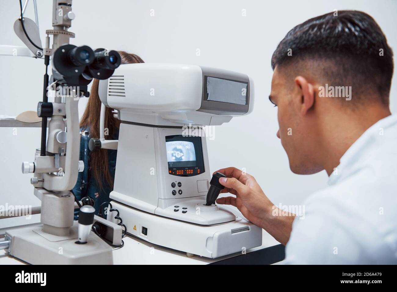 Oculist tests vision of patient by using special modern machine Stock ...