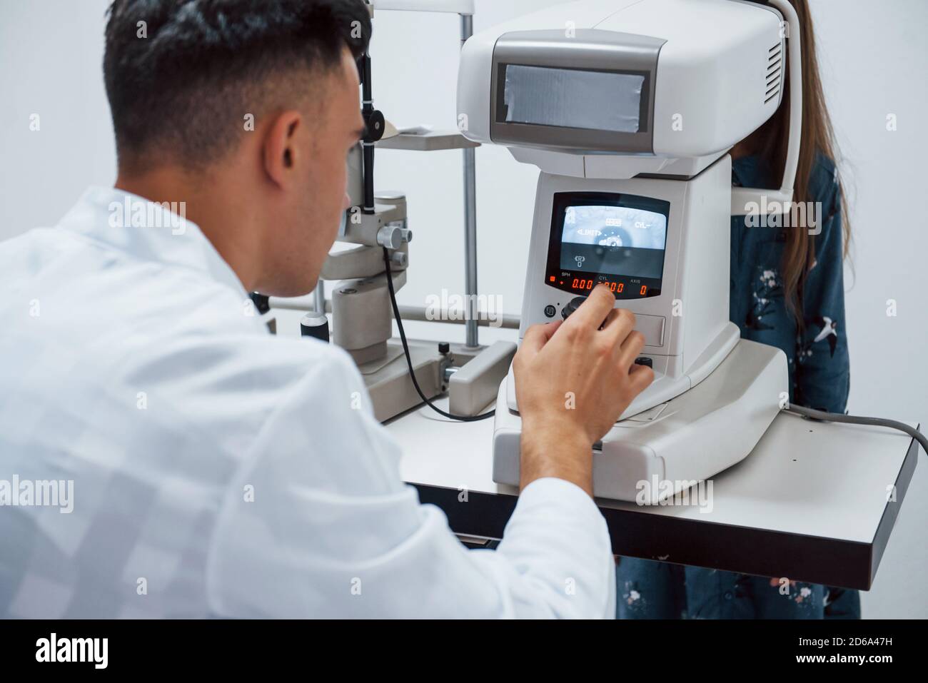 Oculist tests vision of patient by using special modern machine Stock ...