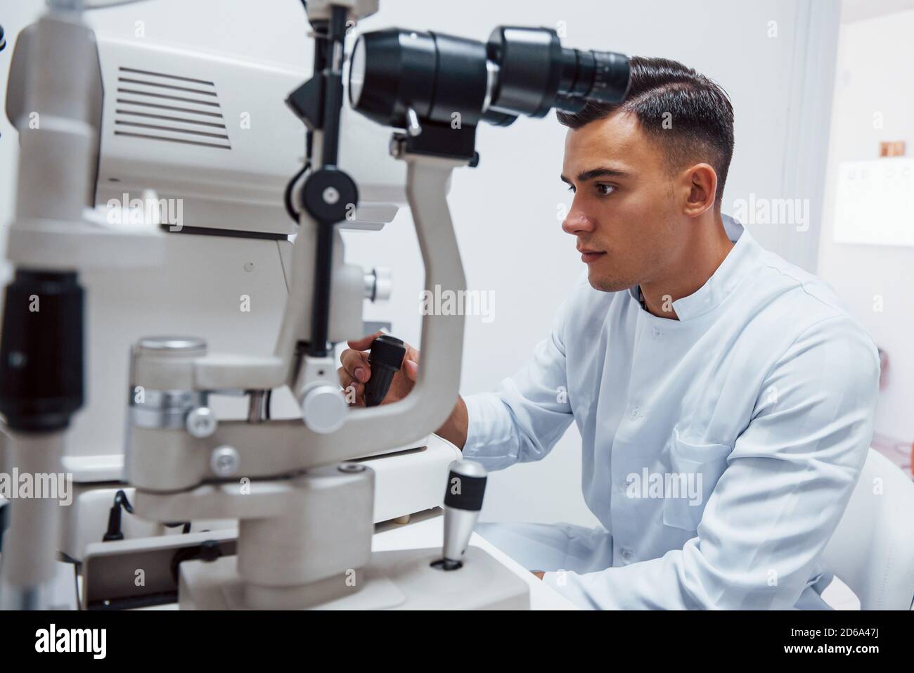 Oculist tests vision of patient by using special modern machine Stock ...