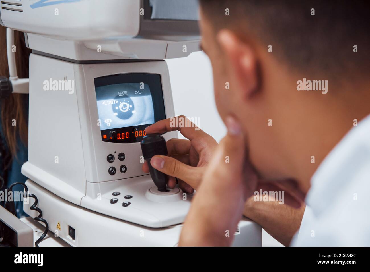 Oculist tests vision of patient by using special modern machine Stock ...