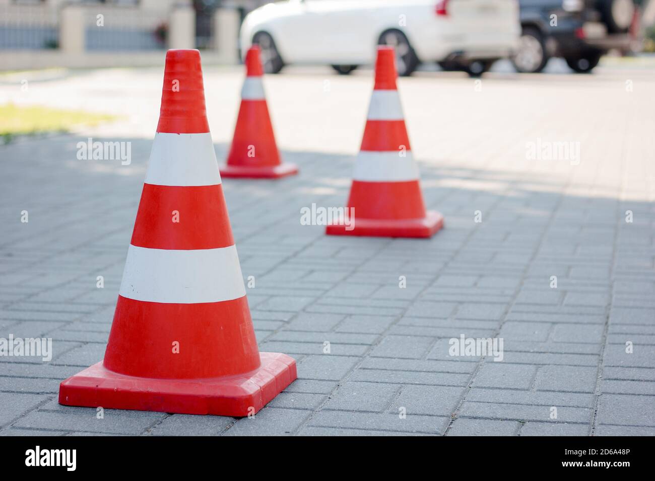 Orange road cone staying at the street Stock Photo - Alamy
