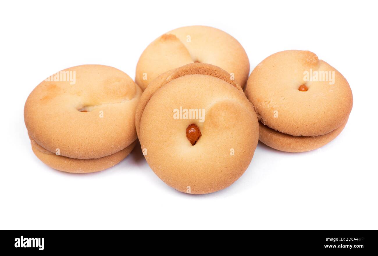 Group of round biscuit cookies with drop of jam in center isolated over ...