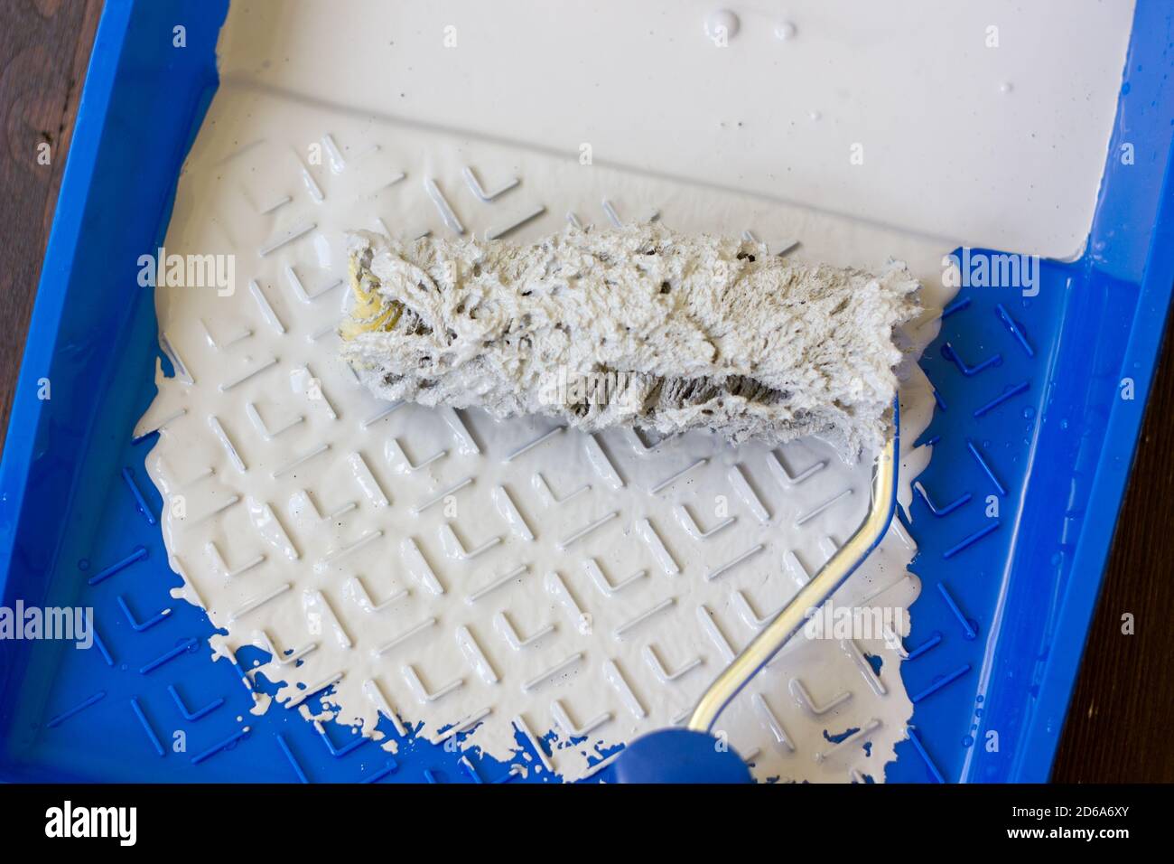 Blue paint tray with paint roller and paint inside it Stock Photo - Alamy