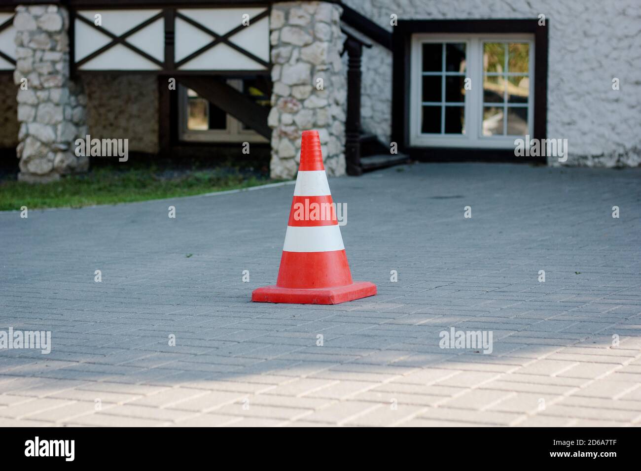Orange road cone staying at the street Stock Photo - Alamy