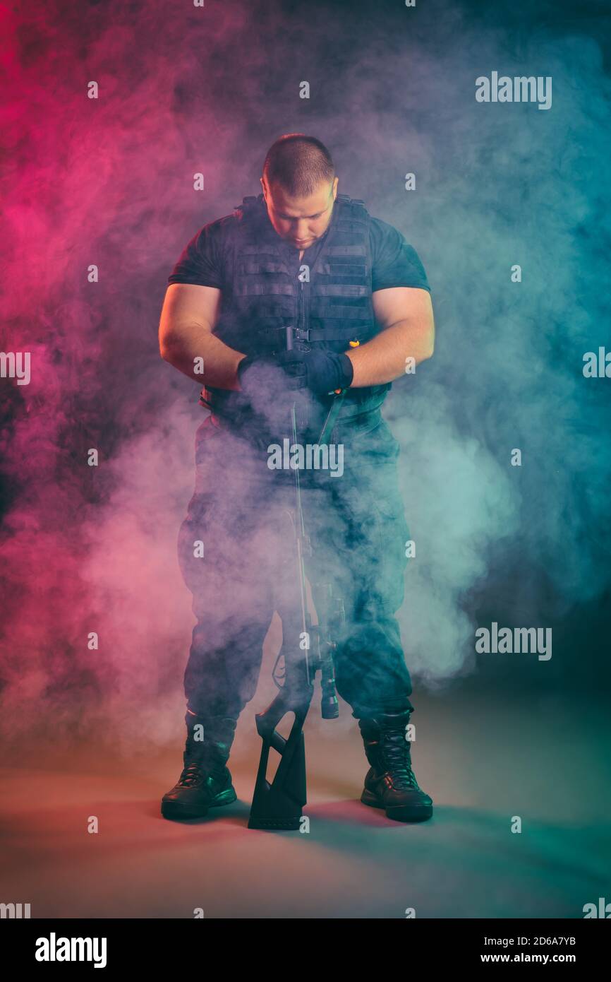 Soldier comes out of the smoke on the battlefield. The concept of ...